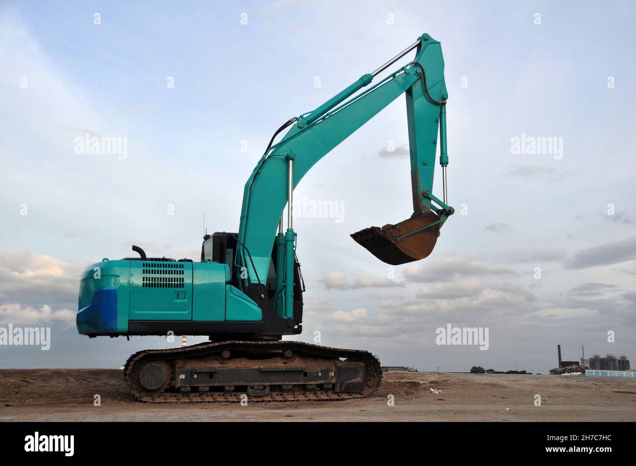 The green excavator vehicle after use and is parked by the port Stock ...