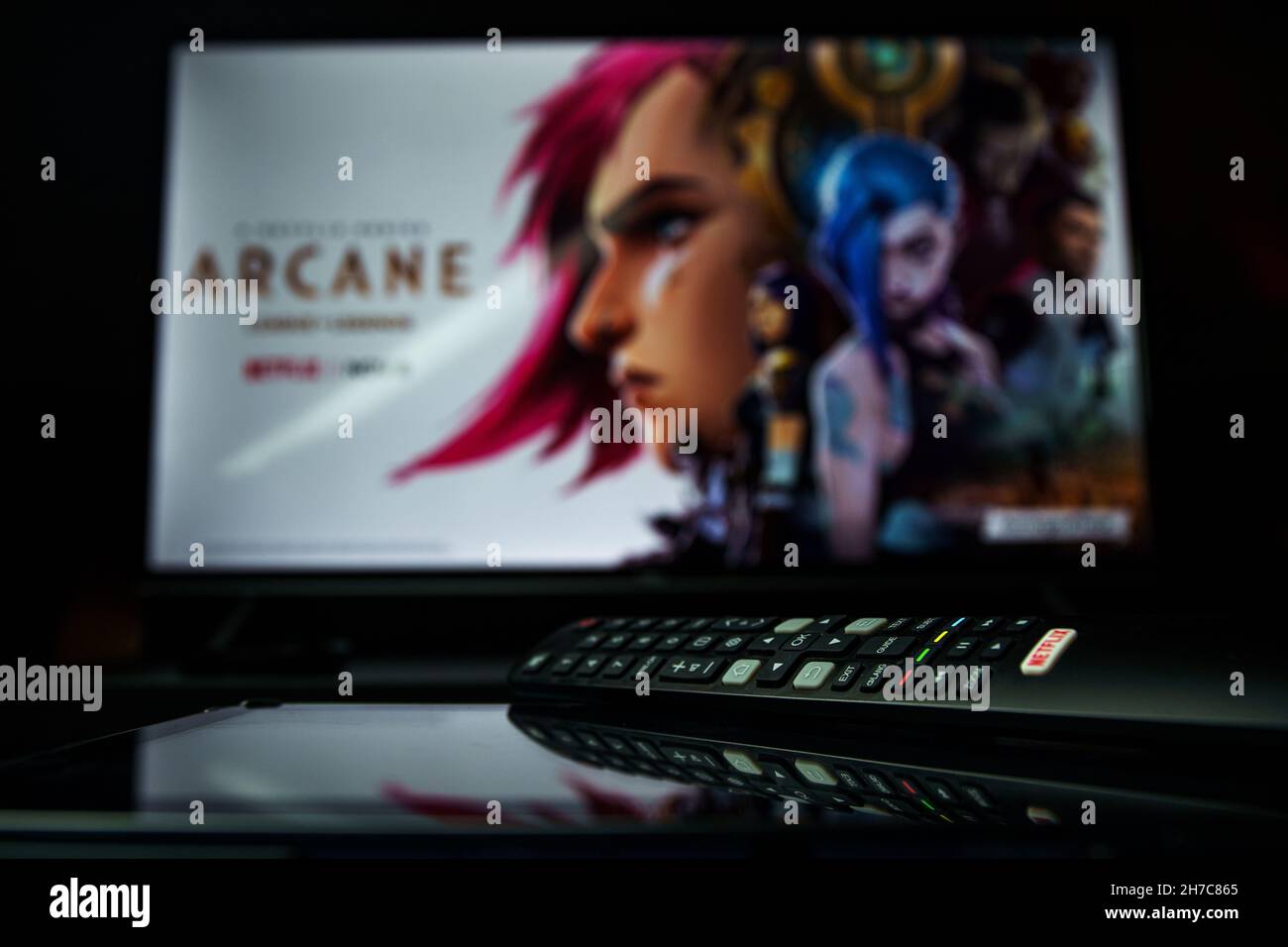 TV remote controller and Arcane Netflix TV series in background. The ...