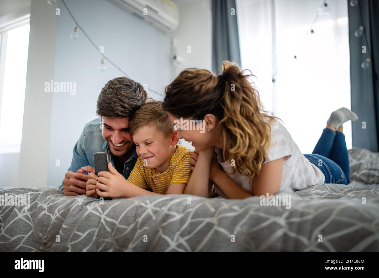 Happy family using digital technology decives for playing watching ...