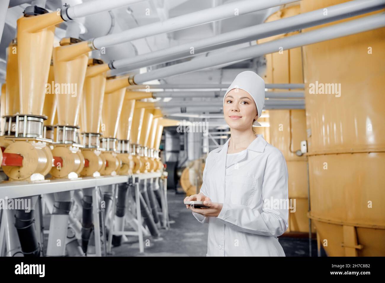 food industry Factory worker inspecting production line tanker in of ...
