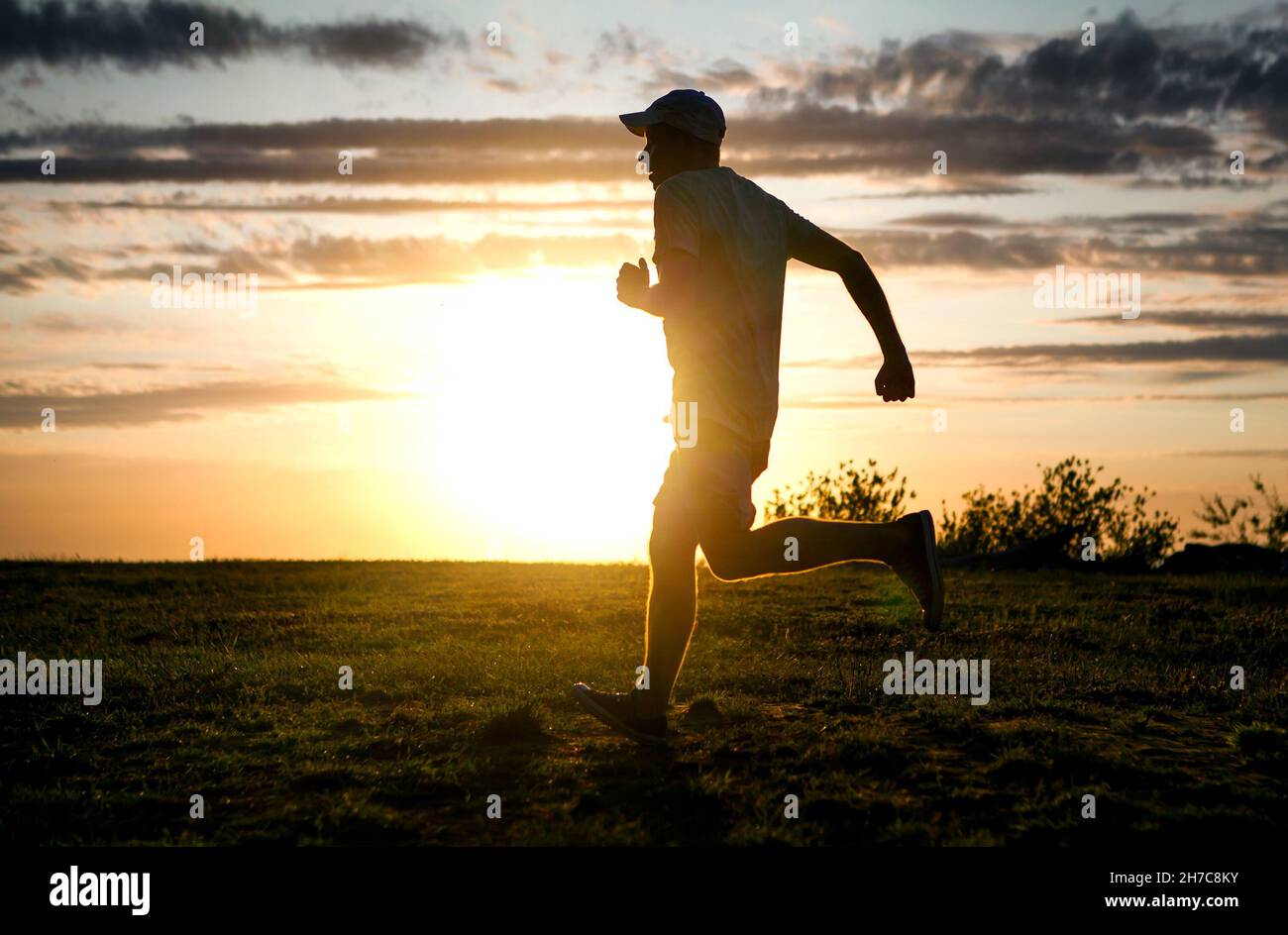 Silhouette of the Man running on the Sunset Background Stock Photo - Alamy