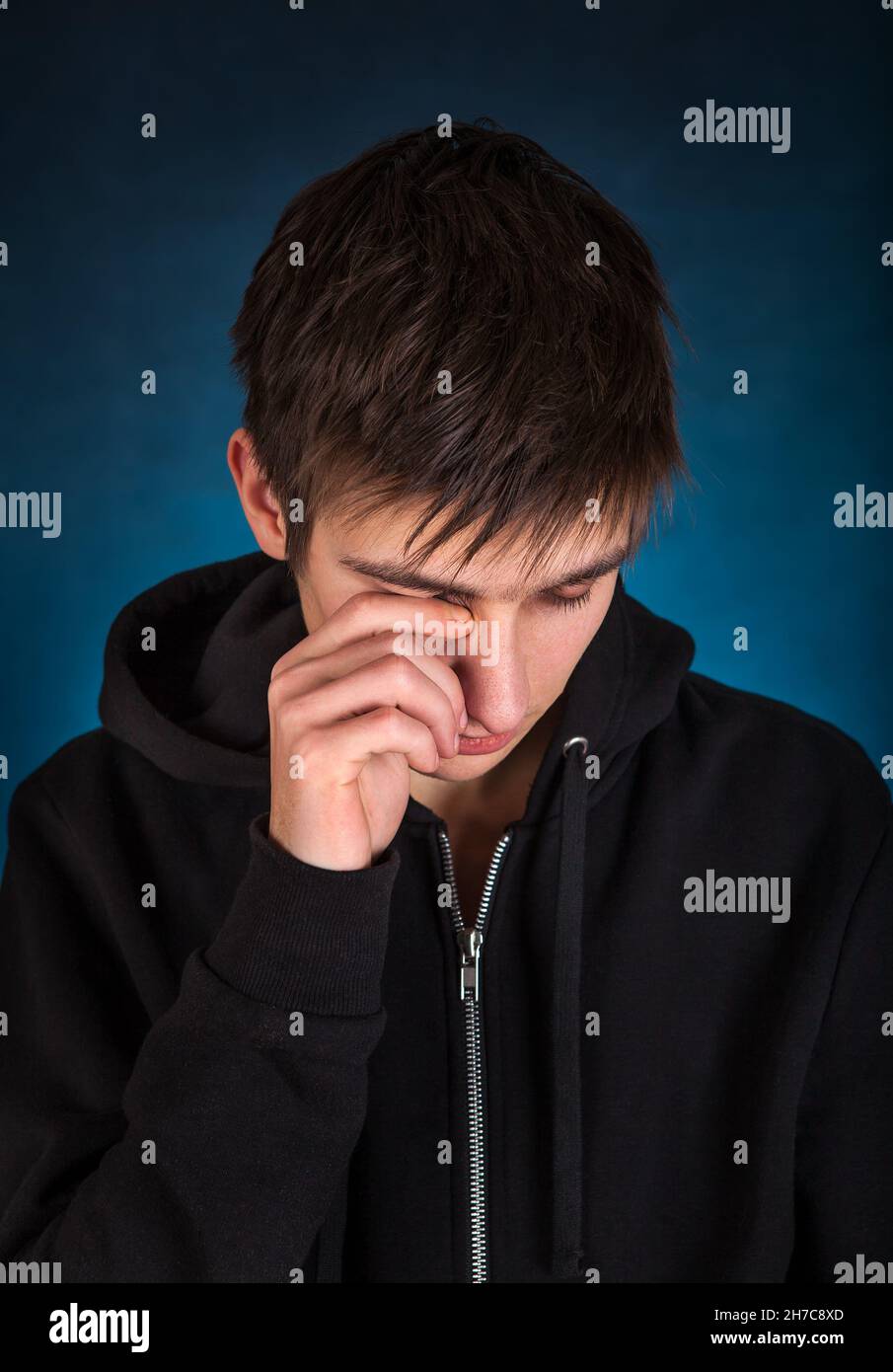 Sad Young Man on the Dark Background Stock Photo - Alamy