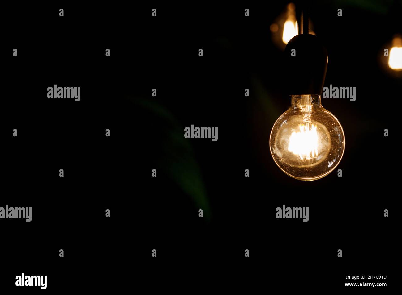 Classic Edison light bulb on black background with space for text Stock ...