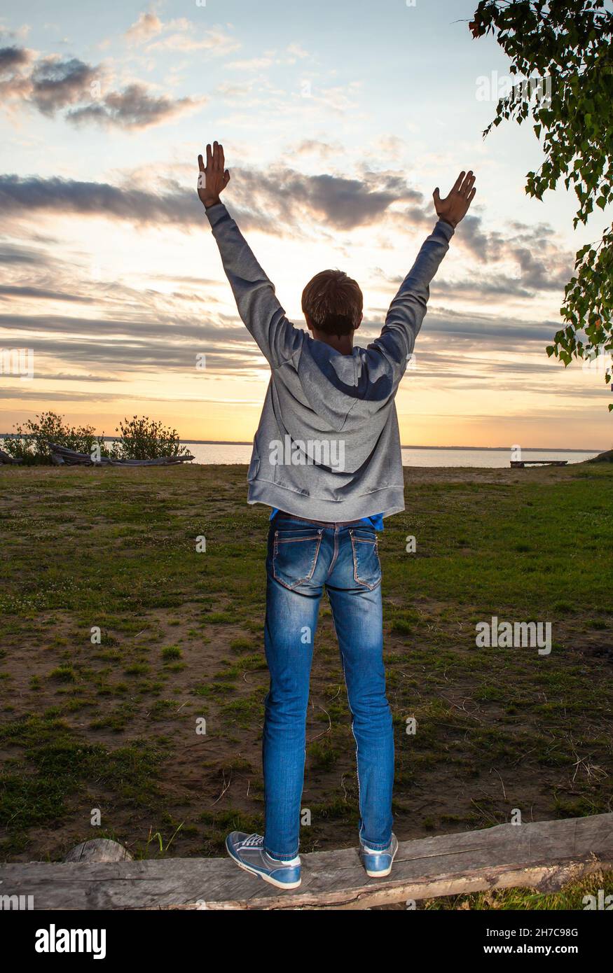 Happy Man Silhouette with Hands Up on the Sunset Background Stock Photo ...
