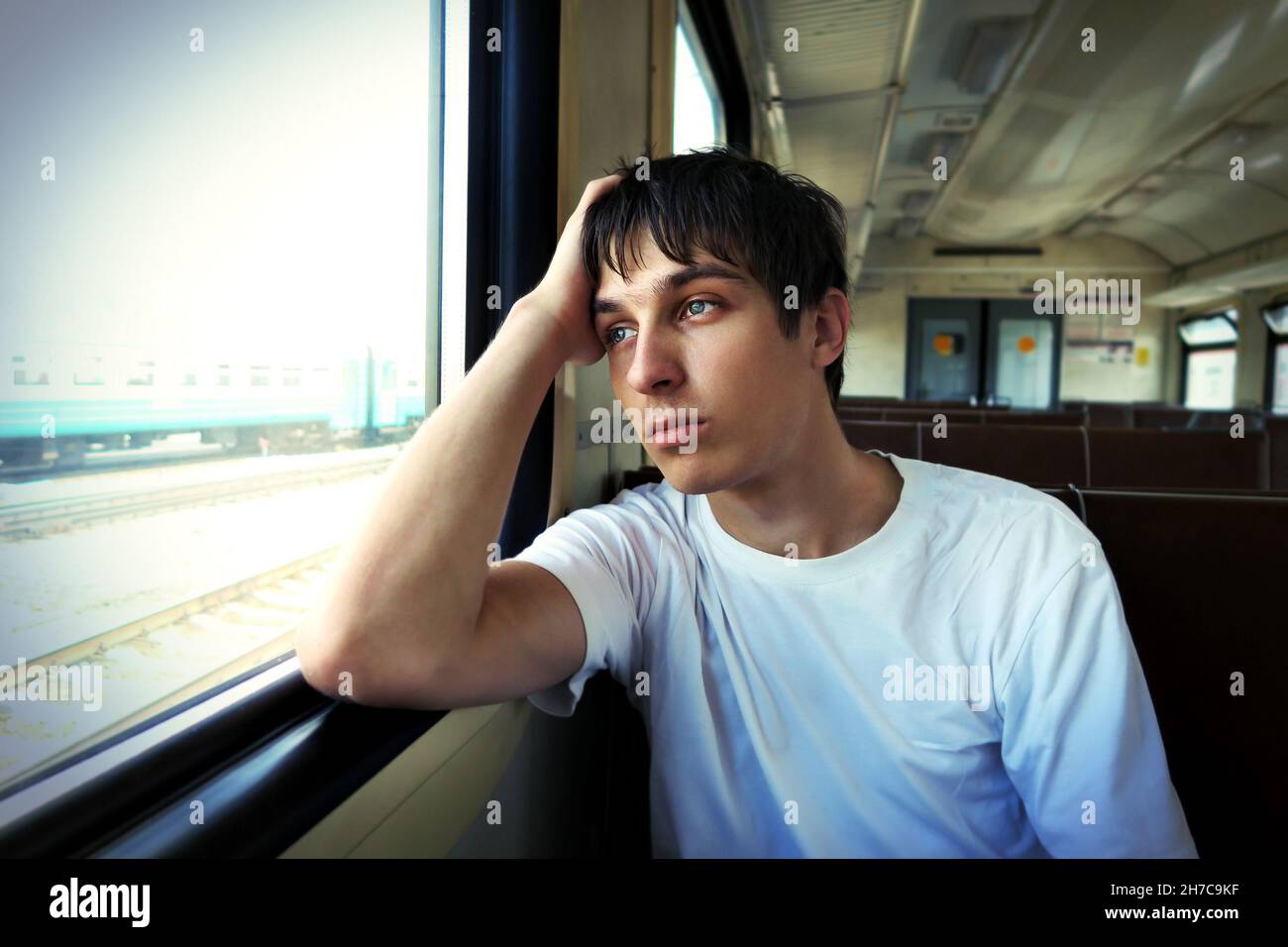 Sad young man in train hi-res stock photography and images - Alamy