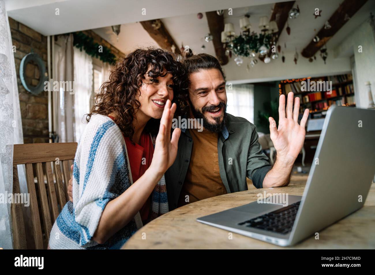 Young smiling couple having online family video call at home Stock ...