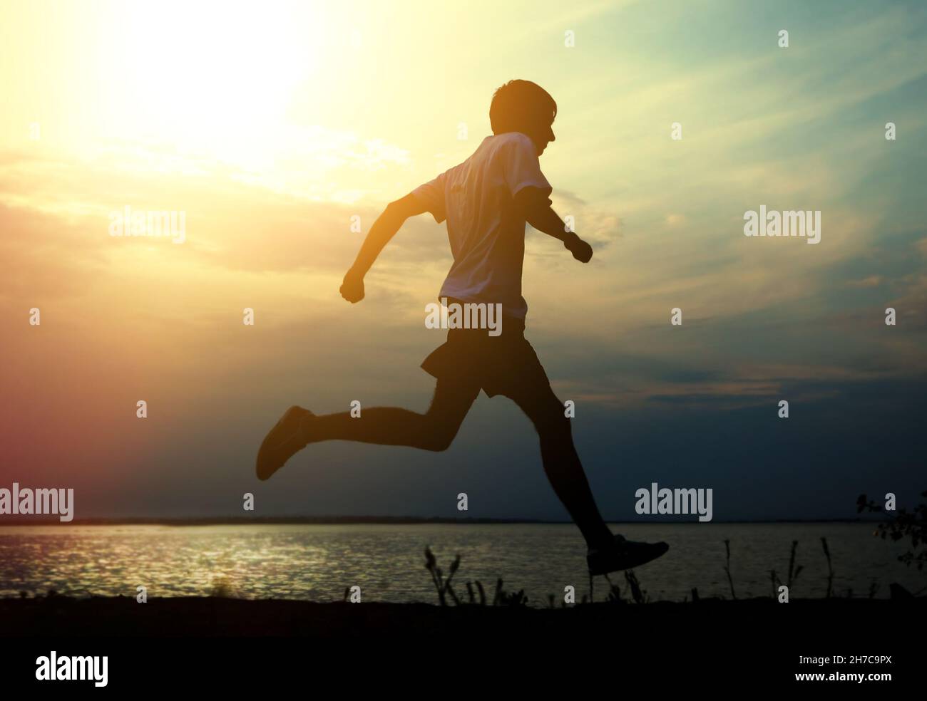 Toned Photo of Silhouette of the Man running on the Sunset Background ...