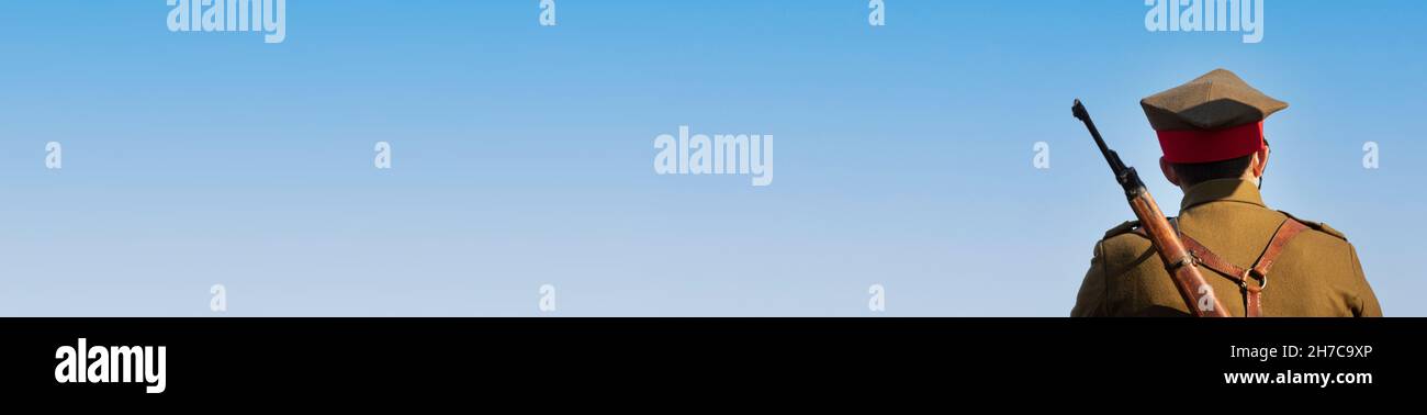 Soldier with rifle on his back against blue sky. Panoramic view Stock ...