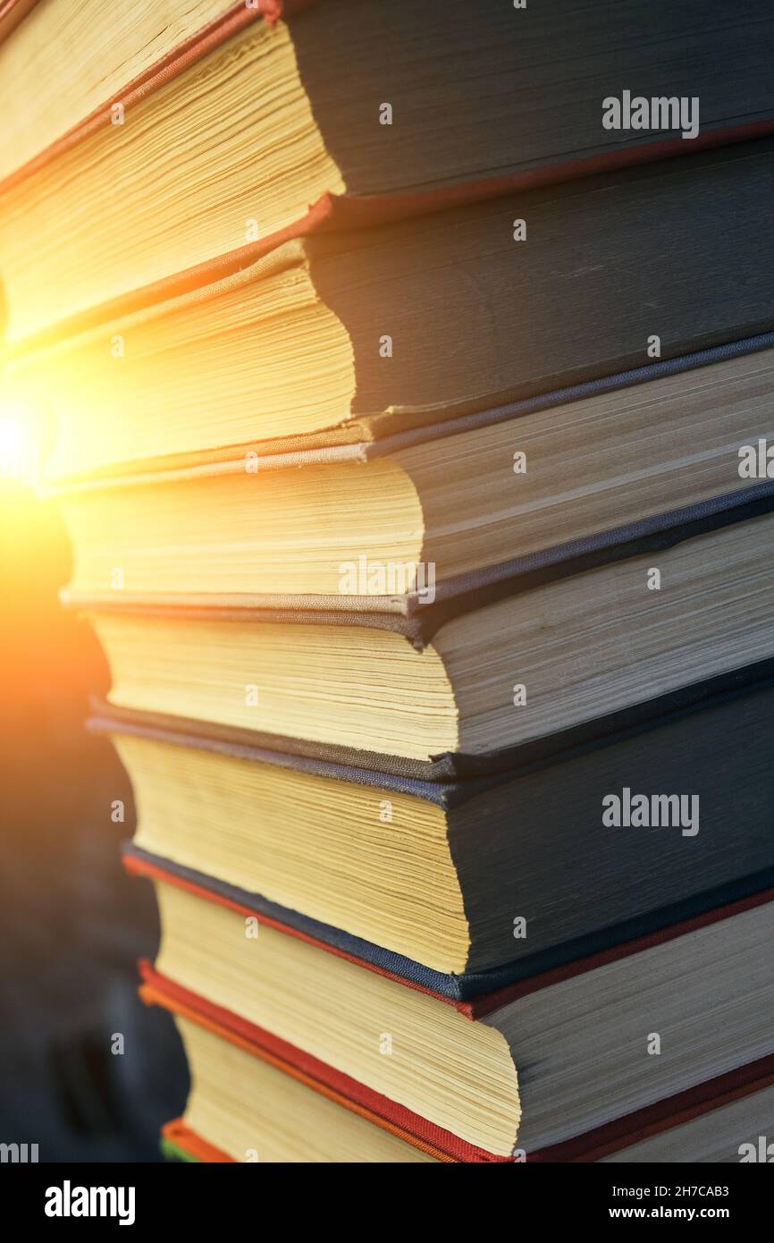 Falling stack of books with a solar flare Stock Photo - Alamy