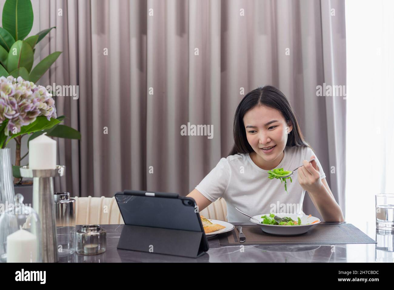 salad concept the lady having Caesar salad and slices of toasted bread ...