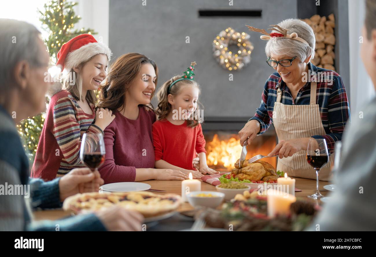 Merry Christmas. Happy family are having dinner at home. Celebration holiday and togetherness ...