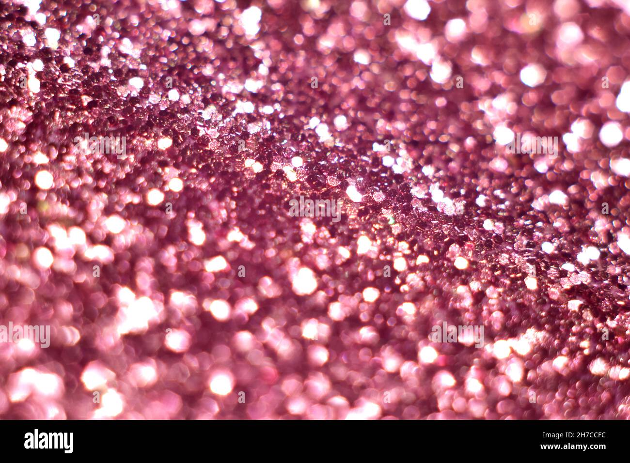 Pink glitter, blurred effect. Glowing holiday light circles are created ...