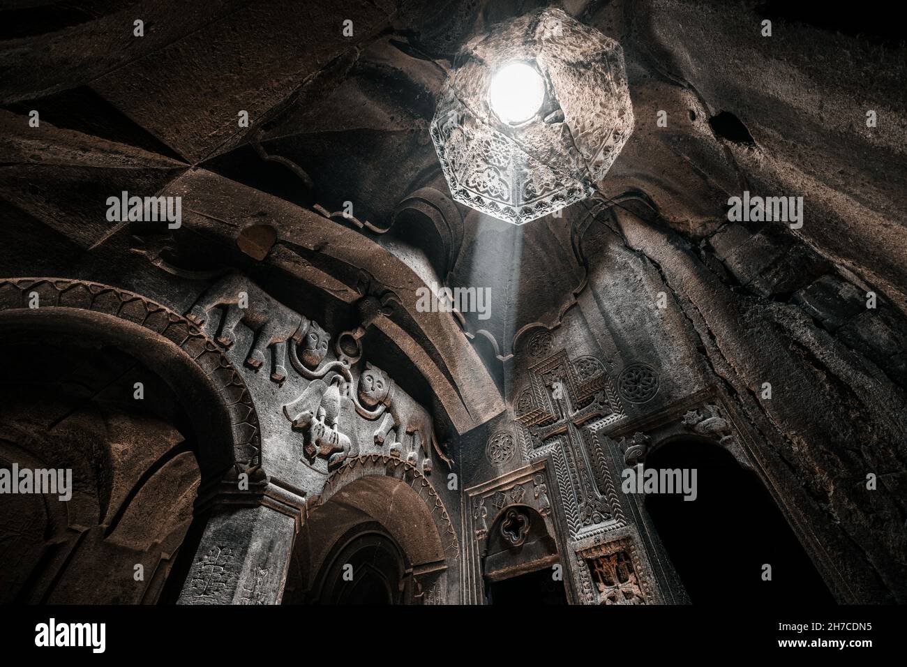 Interior of the famous Geghard Monastery in Armenia. A ray of light ...