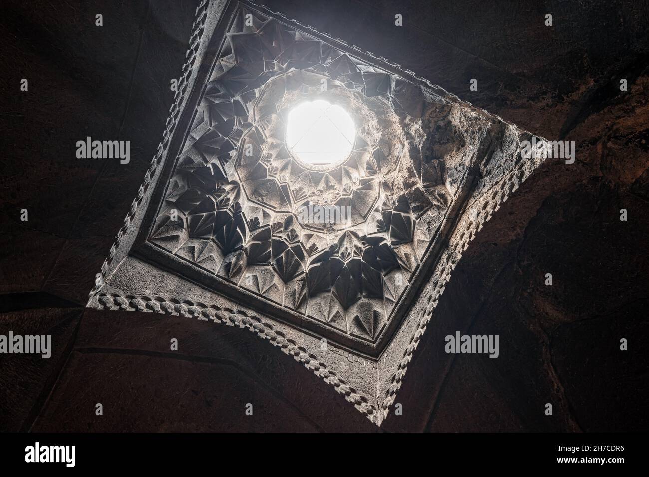The carved ceiling in the Geghard monastery through which a ray of ...