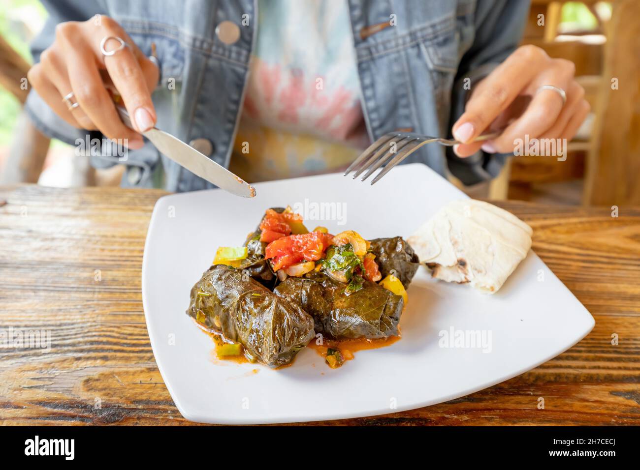 Happy woman eats delicious dolma, a traditional Armenian and Georgian ...