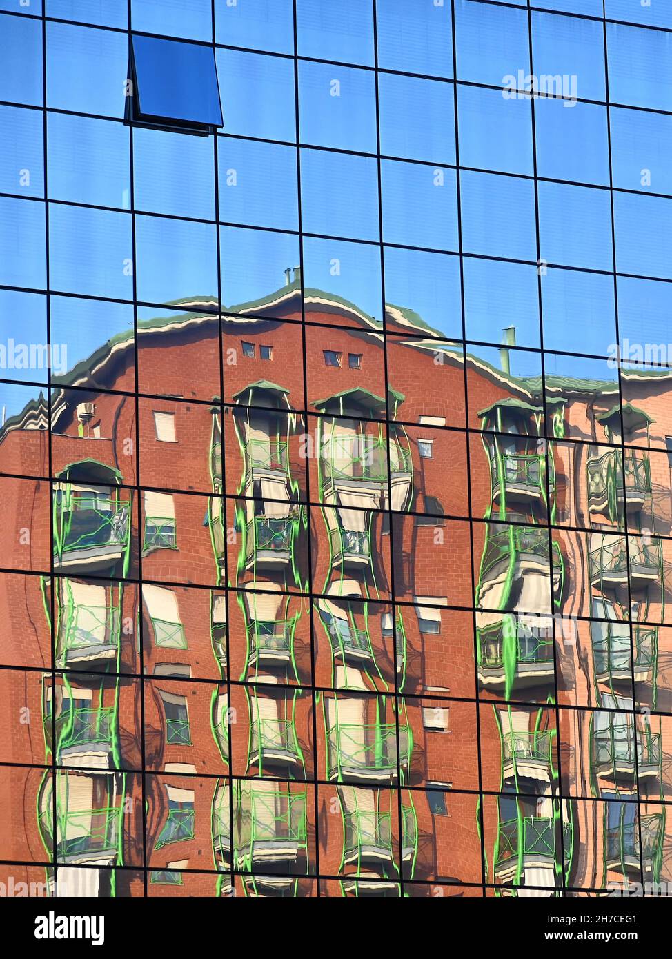 Vertical shot of a distorted reflection of residential buildings in the ...