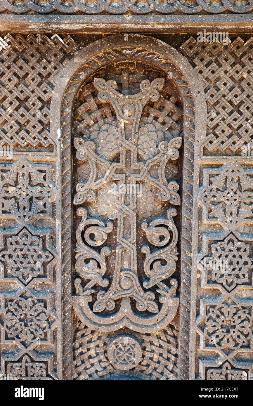 Traditional carved khachkar or cross-stone made of pink tuff installed ...