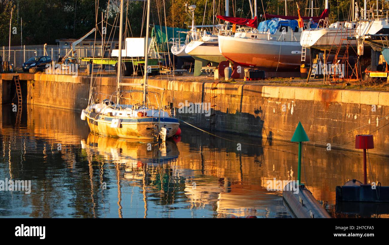 Old boat tied up at the outer dock wall Stock Photo - Alamy