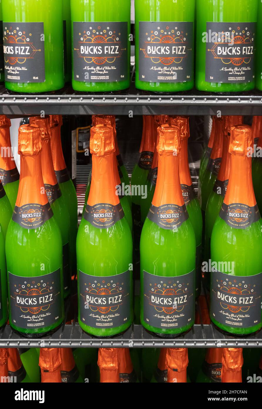 Bootles of Bucks Fizz, white. wine and orange juice, on the shelves of ...