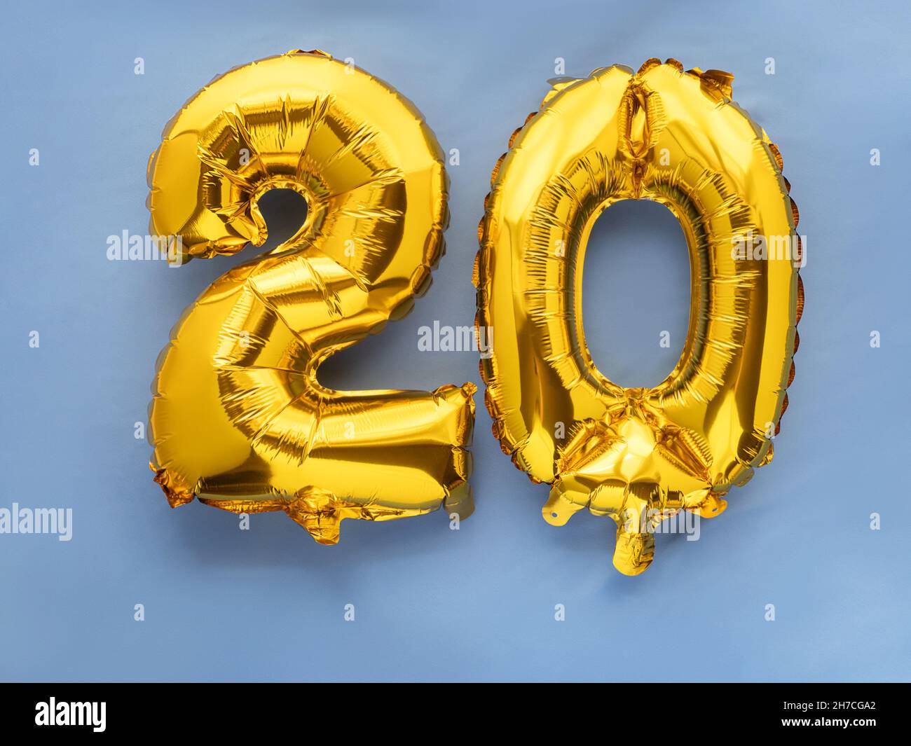 20 golden foil balloon numbers party bunting on blue background Stock ...