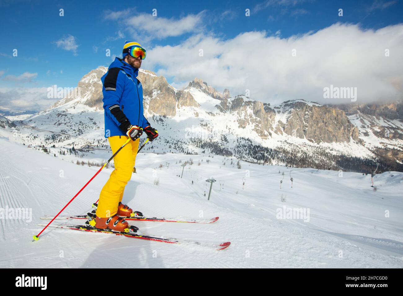 Alpine skier stand on slope in winter mountains Dolomites Italy in ...