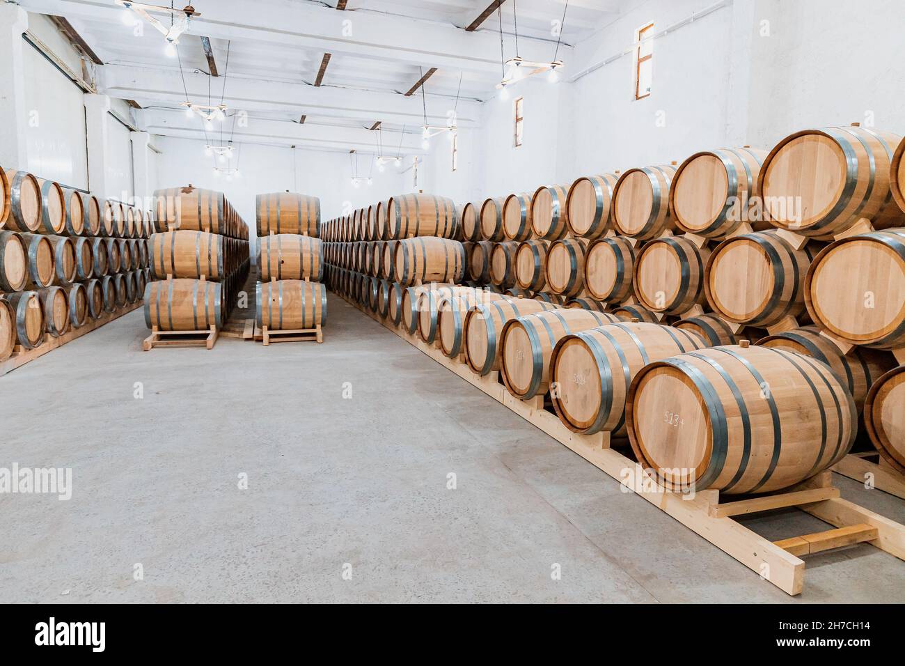 Wine wooden barrels in the cellar of the winery. Process of aging and ...