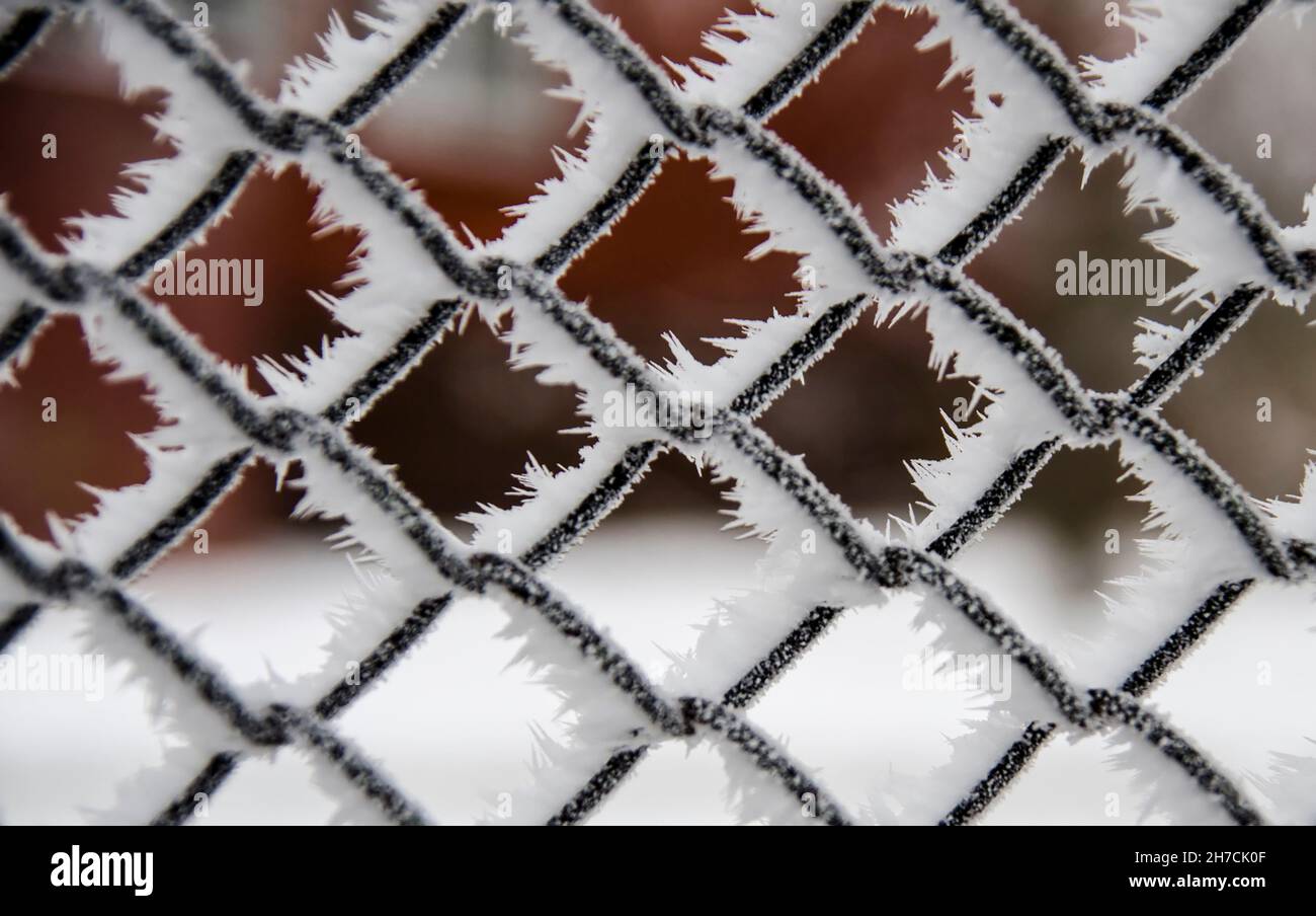 Frozen icy metal grid covered with snow Stock Photo - Alamy