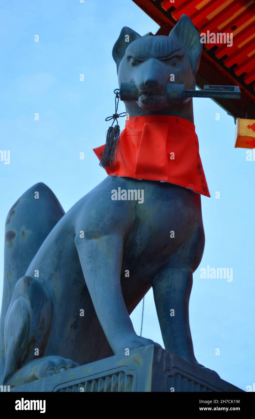 Vertical shot of a Japanese temple guardian with the clear skies in the ...