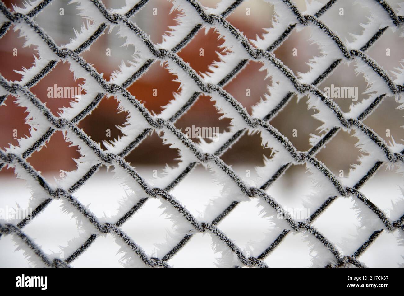 Frozen icy metal grid covered with snow Stock Photo - Alamy