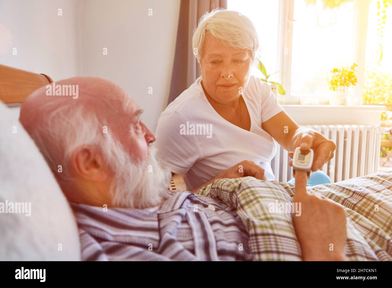 Nursing service to measure the pulse and heart rate at home Stock Photo ...