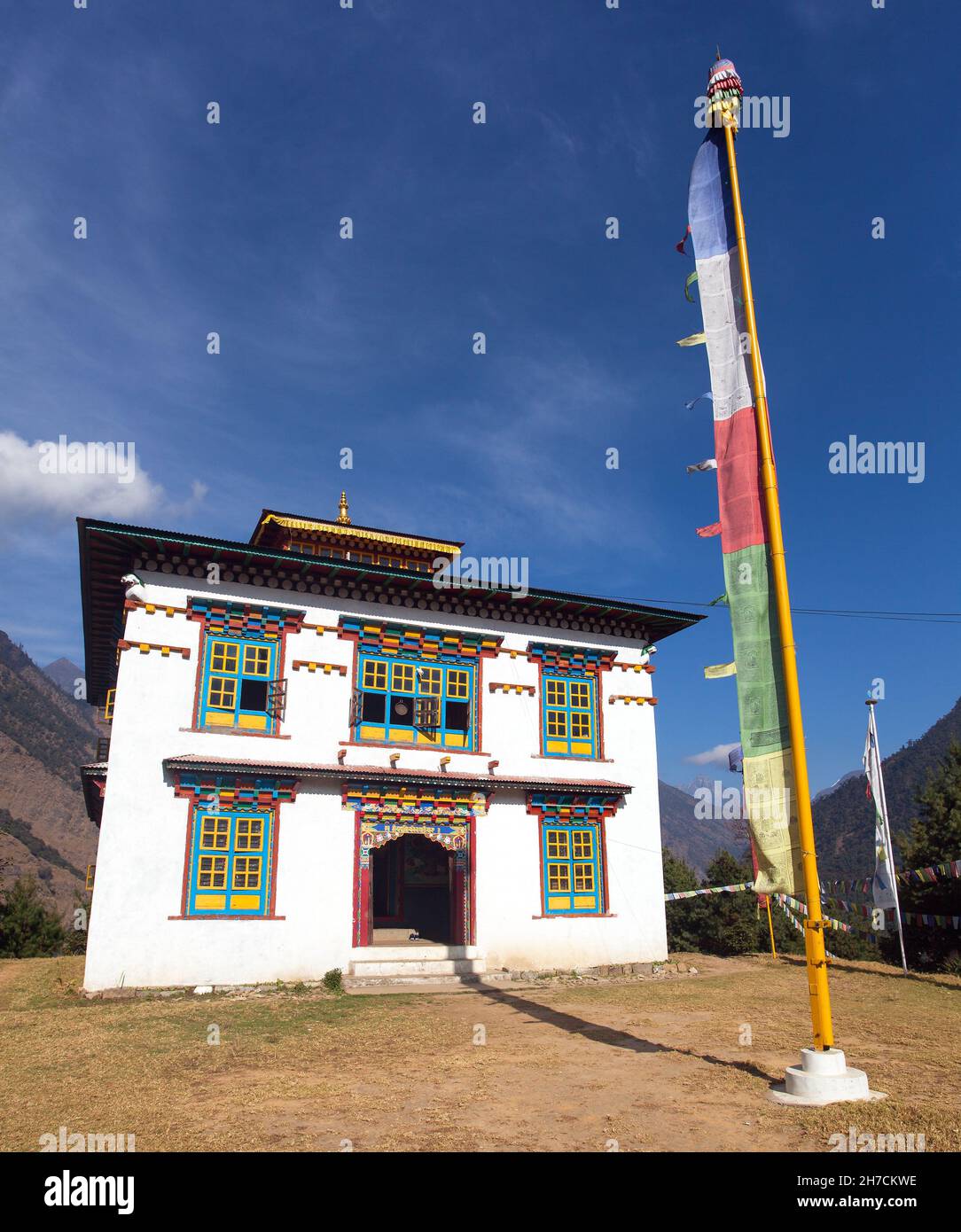 Buddhist monastery or gompa in Kharikhola village with prayer flafs ...
