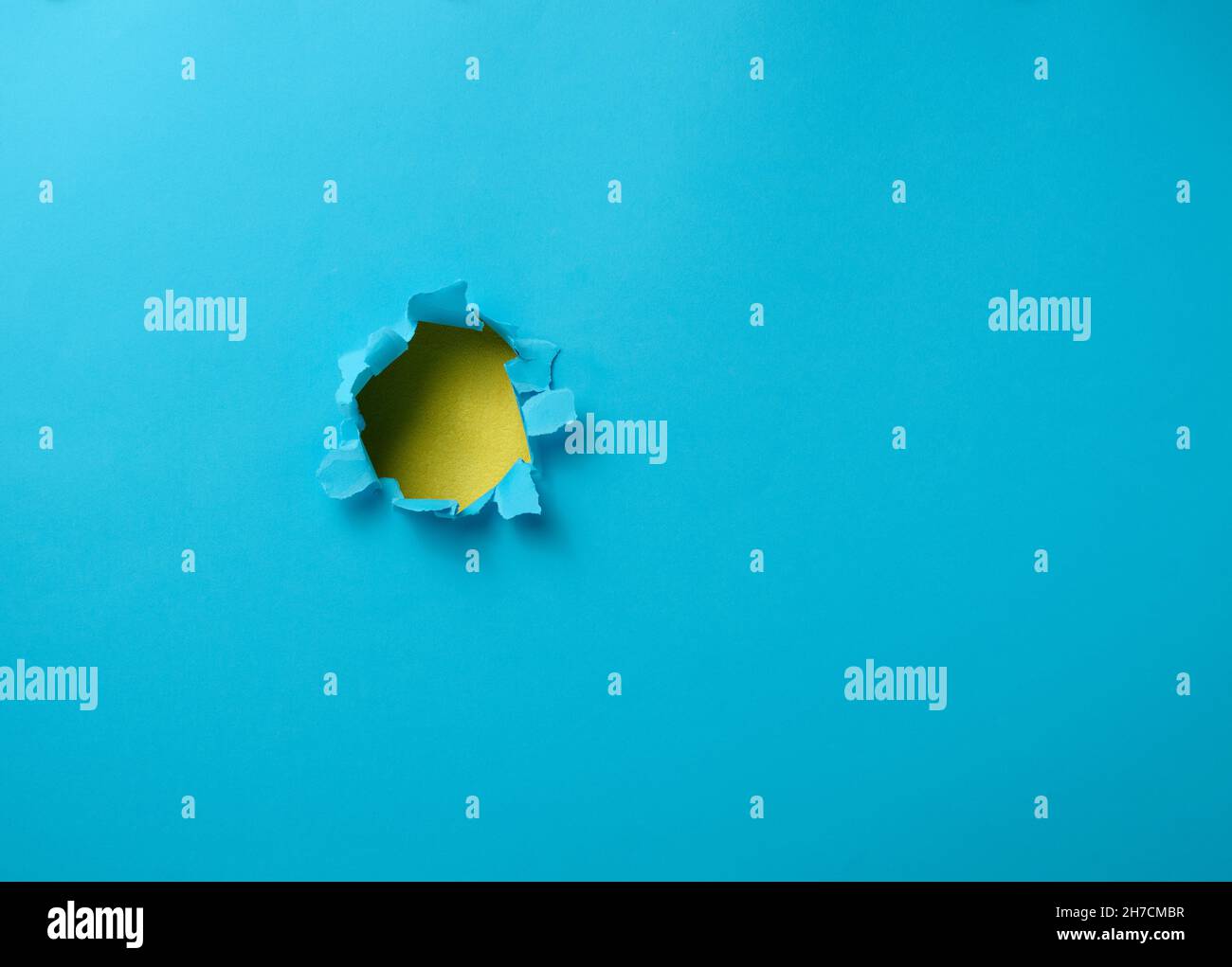 hole with torn edges in blue paper, full frame. Copy space Stock Photo ...