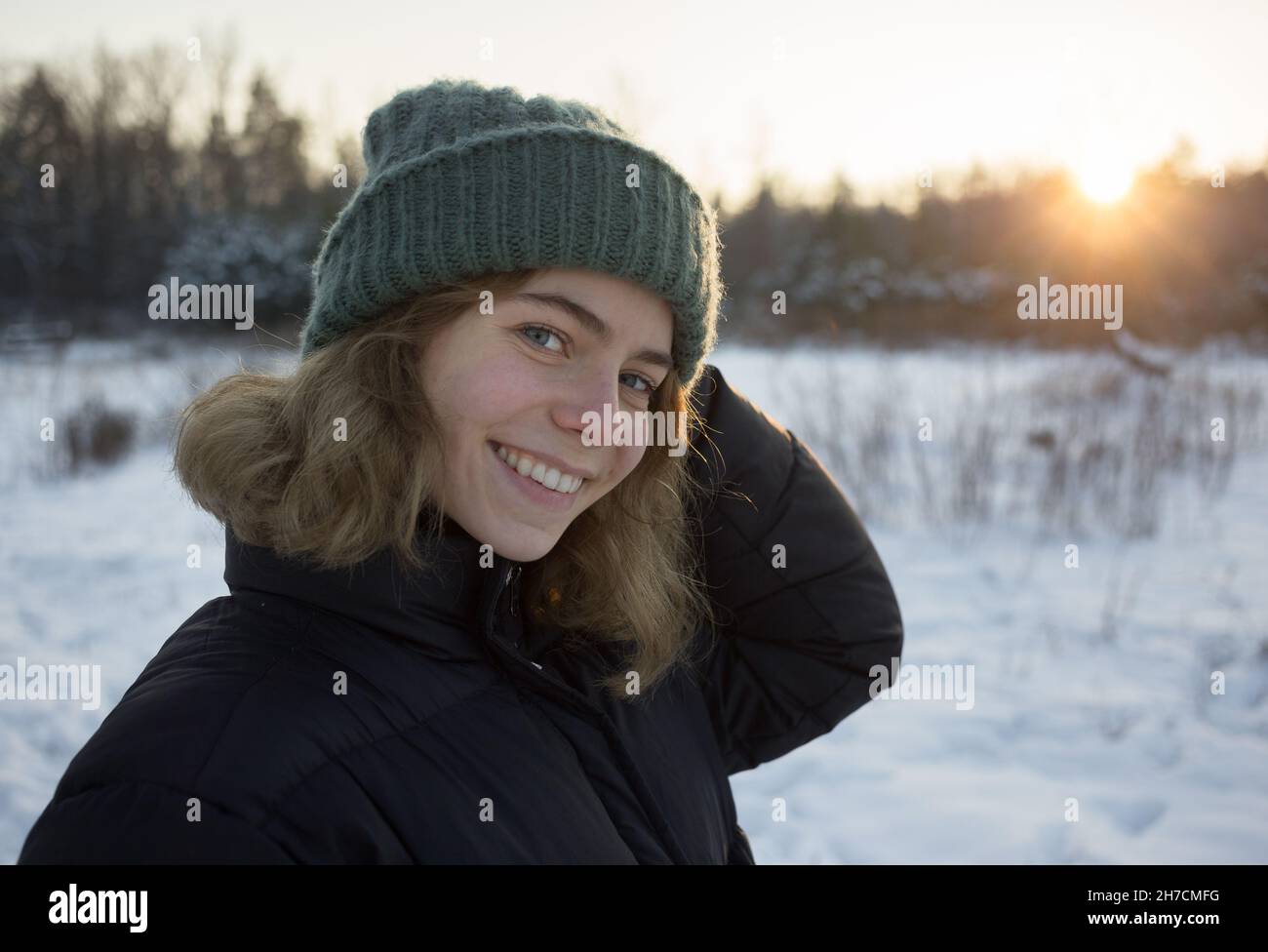 cute teenage girl in warm winter clothes in a good mood smiling while ...