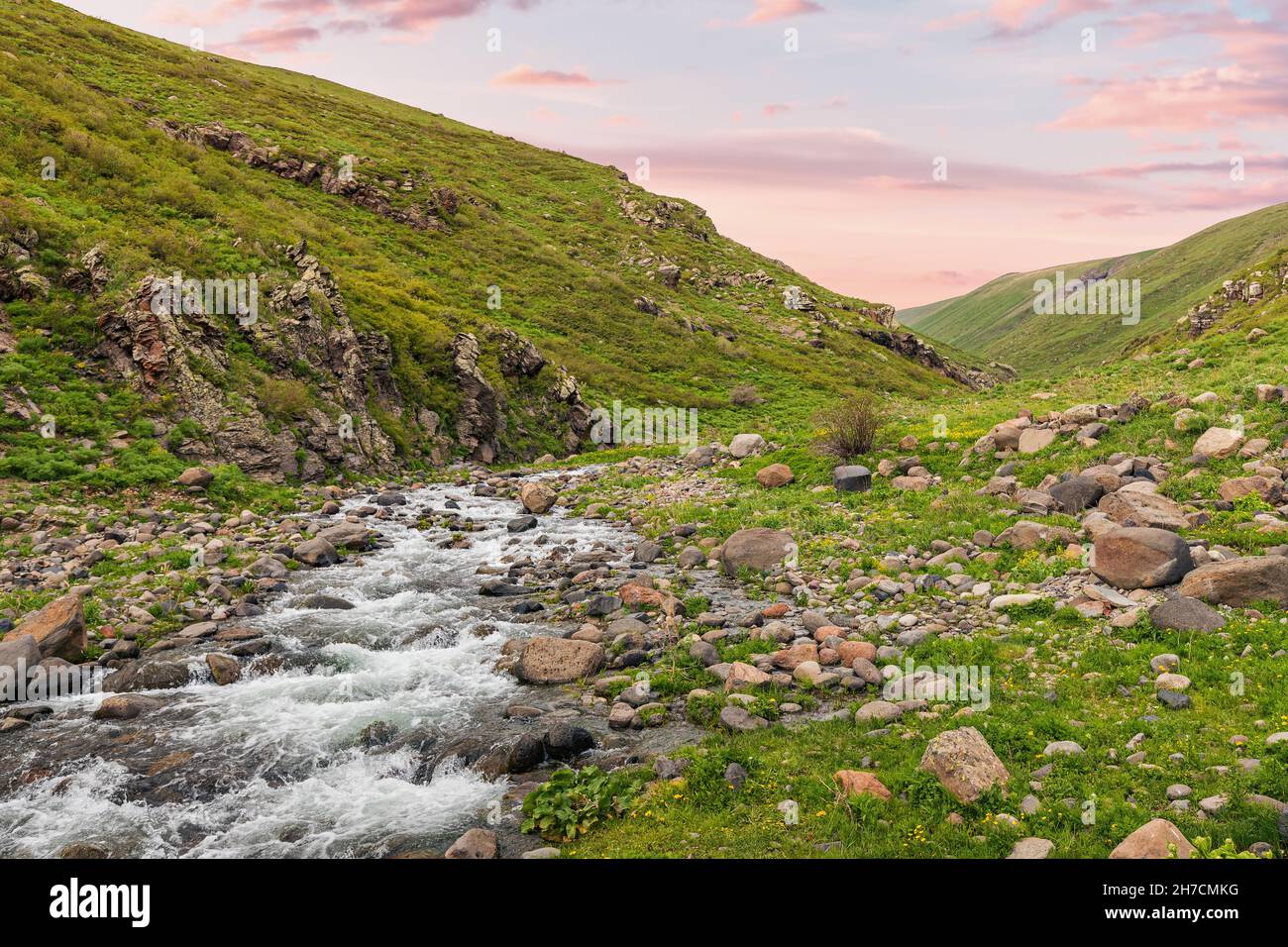 Idyllic Armenian landscape with mountains and a stream. On the slope of ...