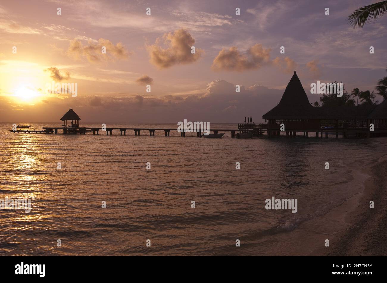 stilt huts in a hotel complex at the palm beach, French Polynesia ...