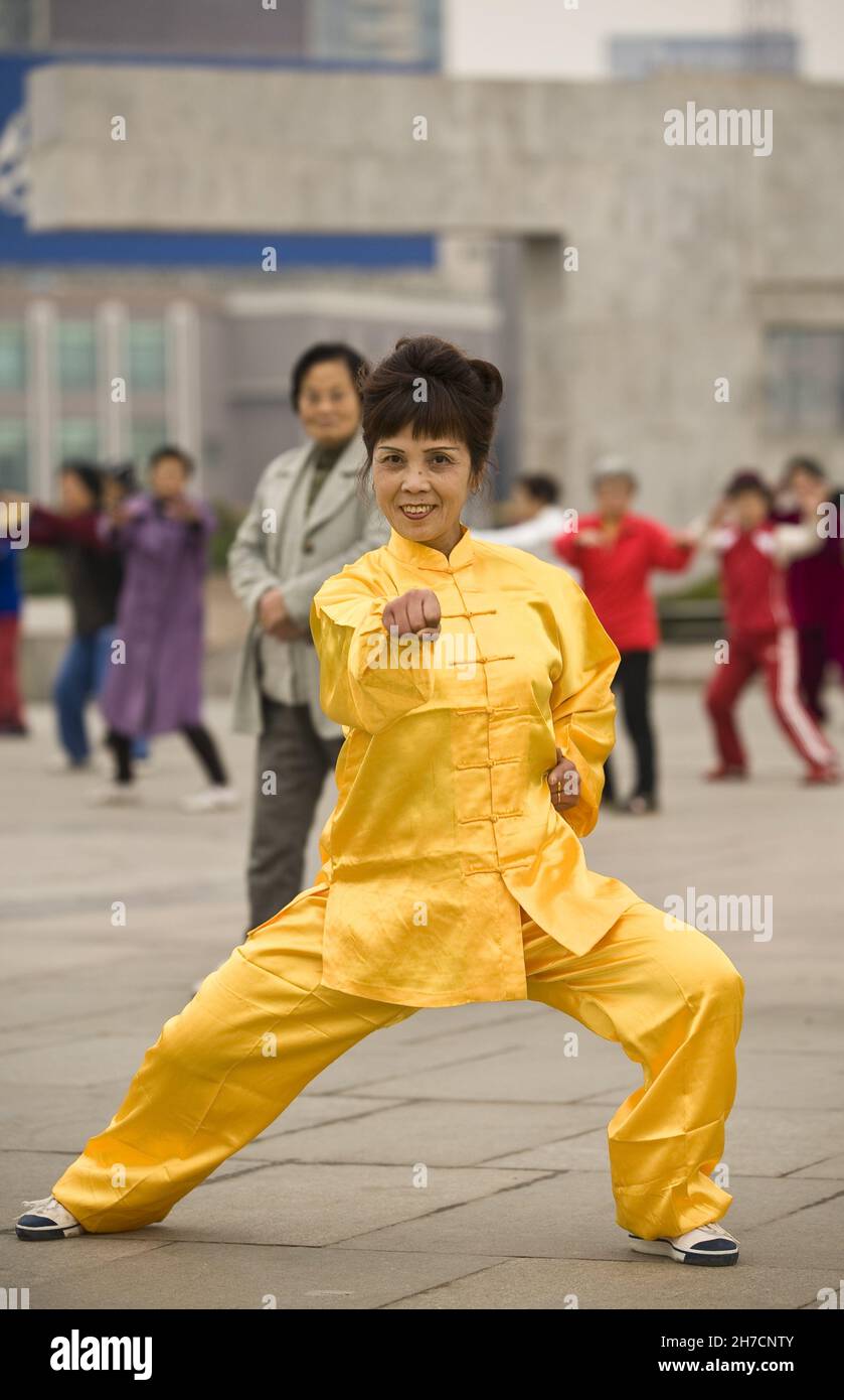 woman in Tai Chi clothing doing morning Tai Chi at the Bund on ...