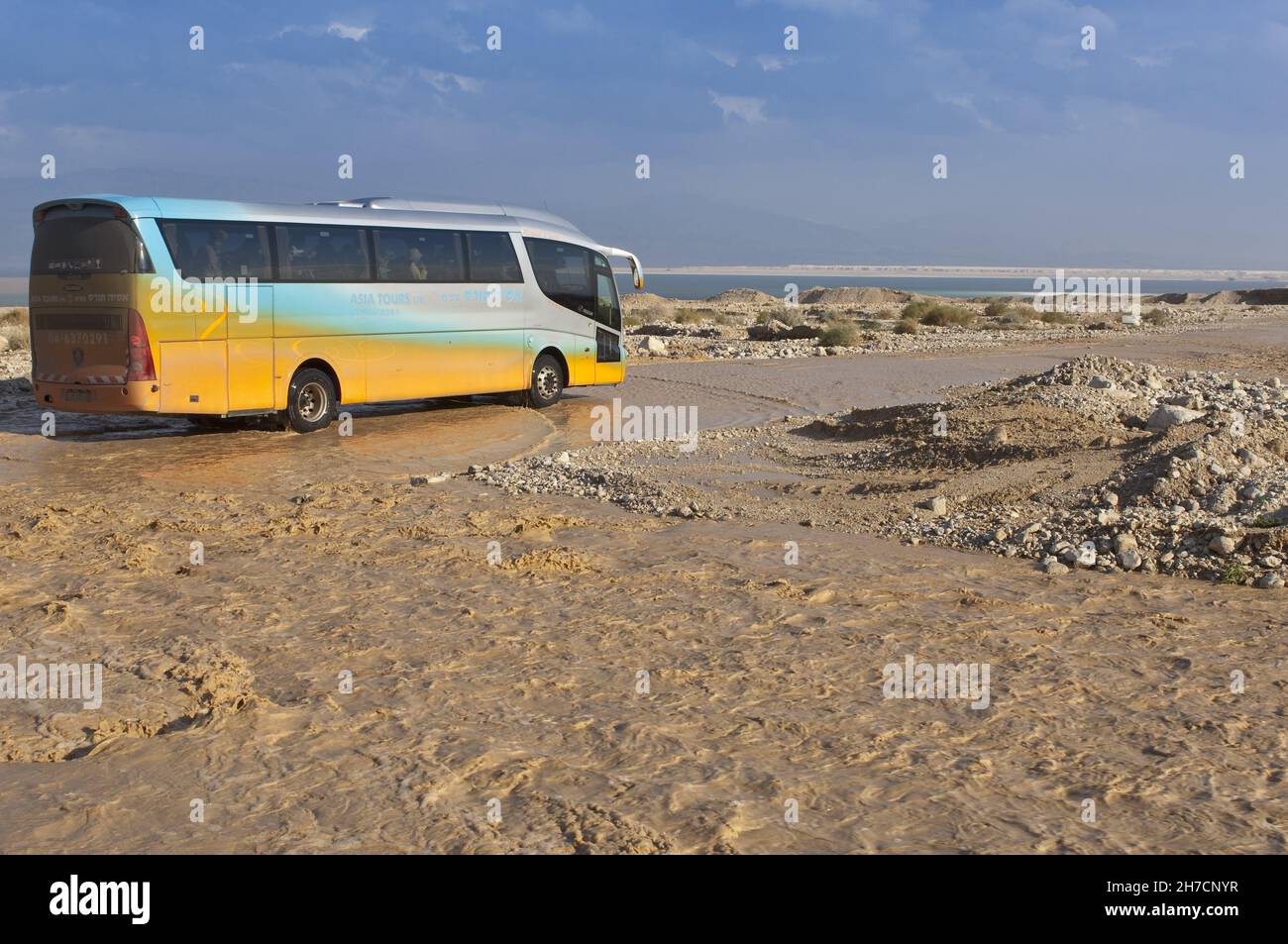 overland bus driving over a flooded road at the Dead Sea, Israel Stock ...