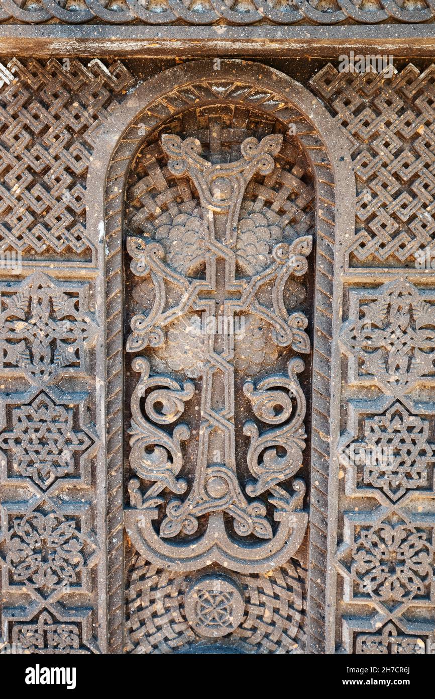 Traditional carved khachkar or cross-stone made of pink tuff installed ...