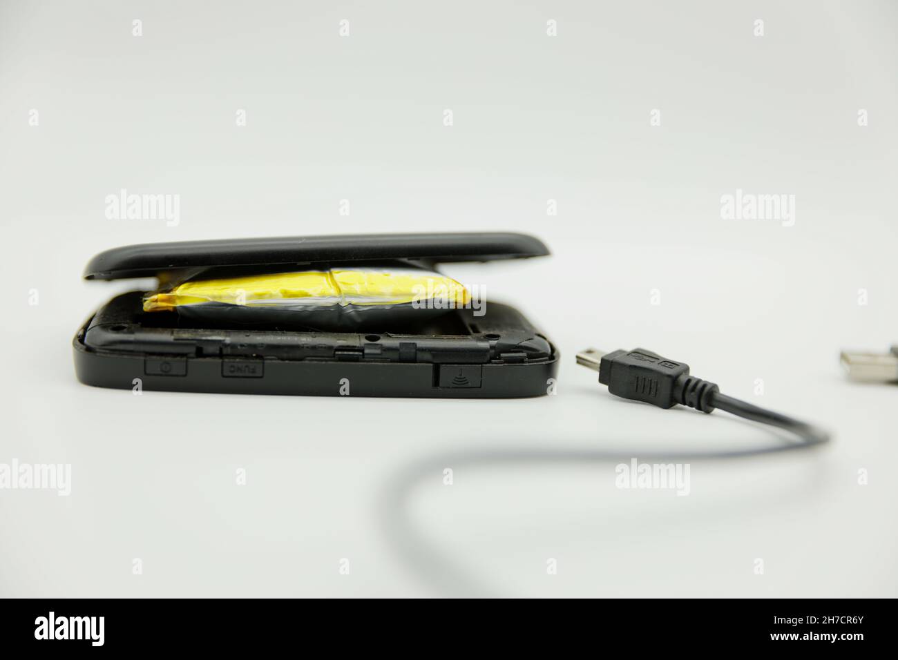 Closeup shot of a damaged and swollen battery in the mini route ...