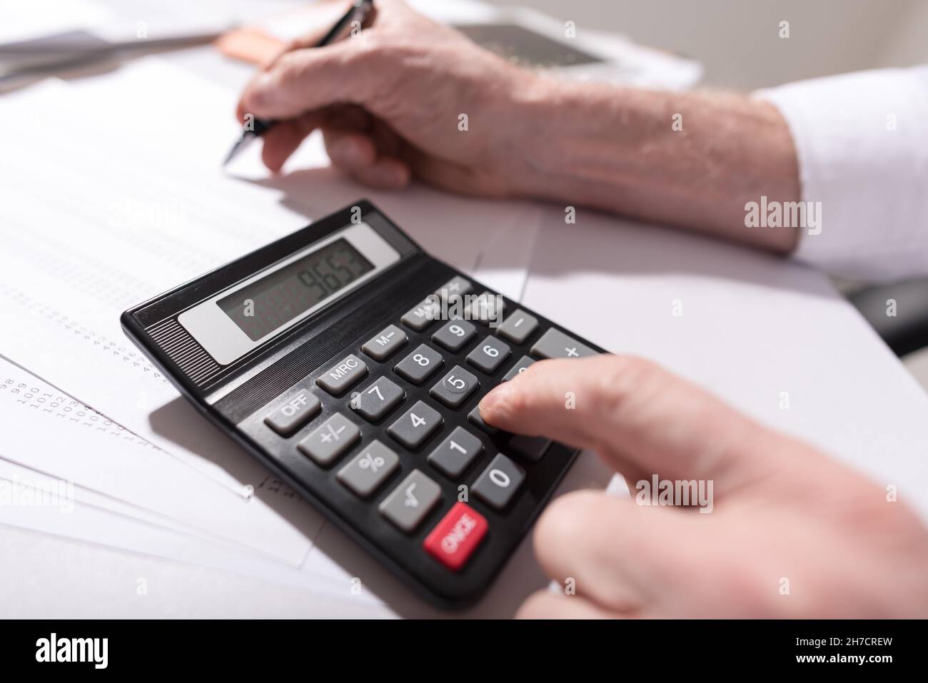 Male hand using calculator, accounting concept Stock Photo - Alamy