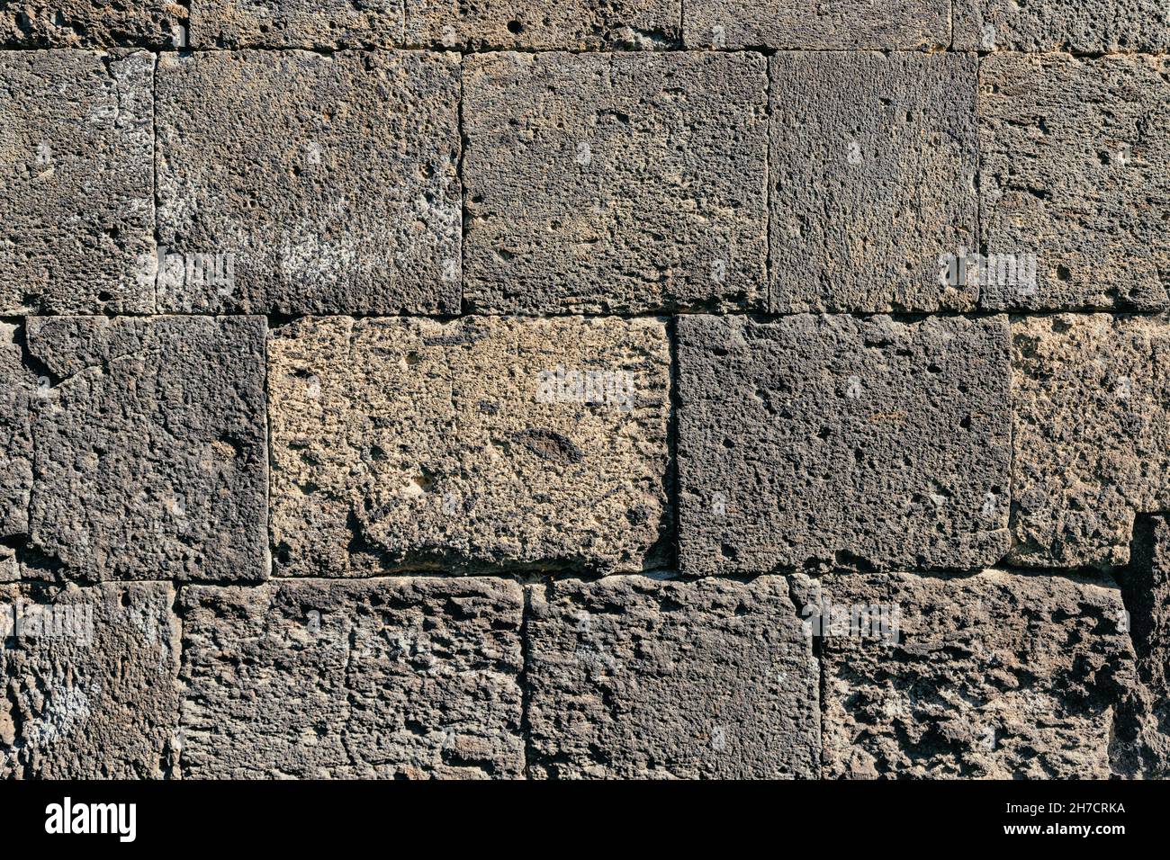 Background and texture of a grey stone masonry in the wall of an ...