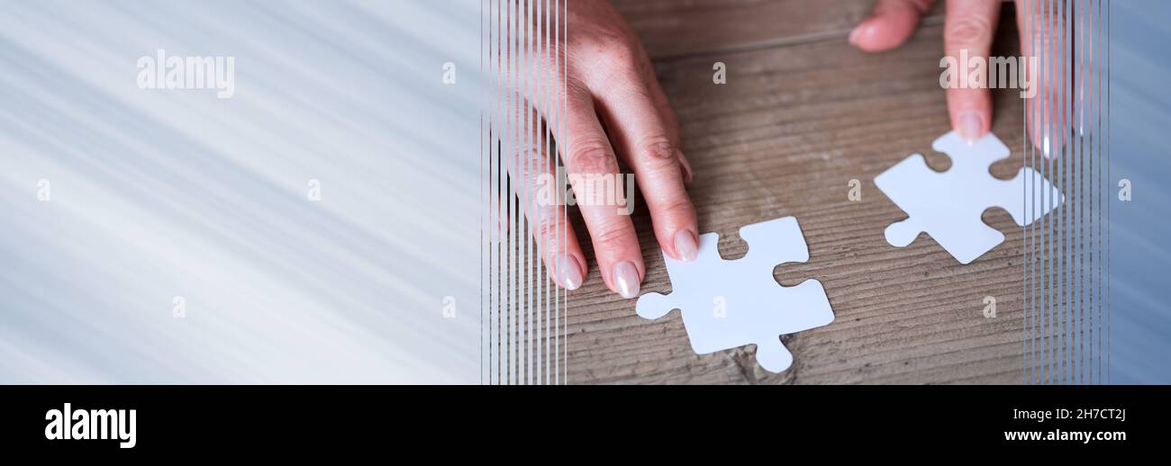 Hands joining two puzzle pieces, teamwork concept. panoramic banner ...