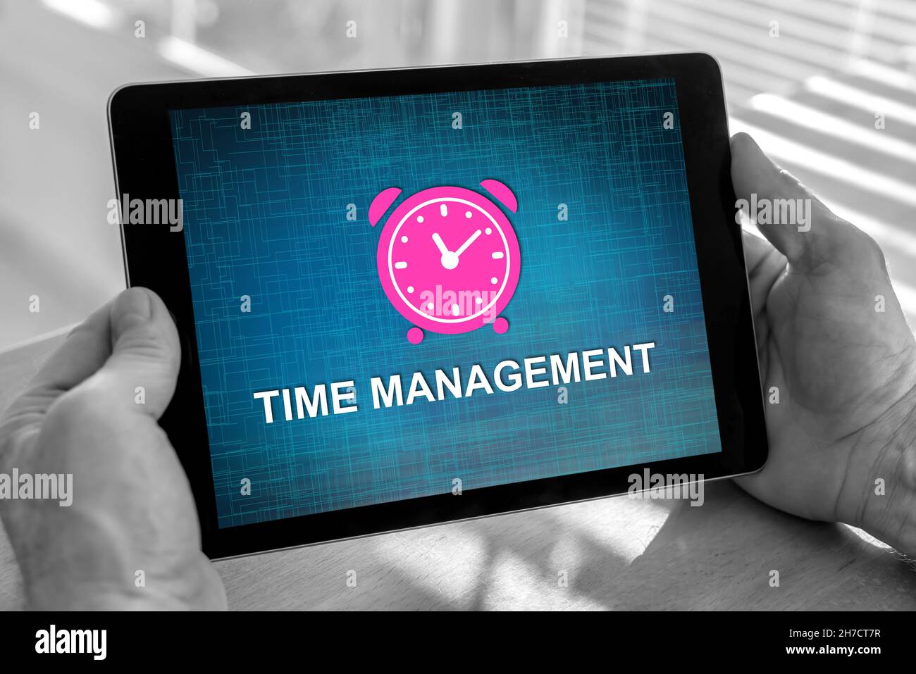 Male hands holding a tablet with time management concept Stock Photo ...