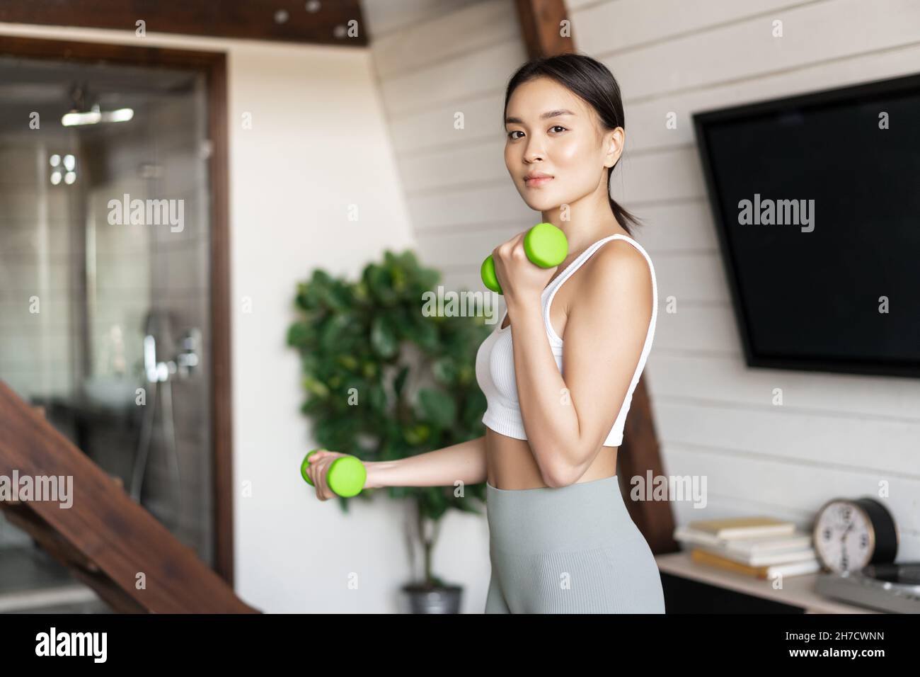 Active and healthy asian girl with fit body doing fitness exercises at ...