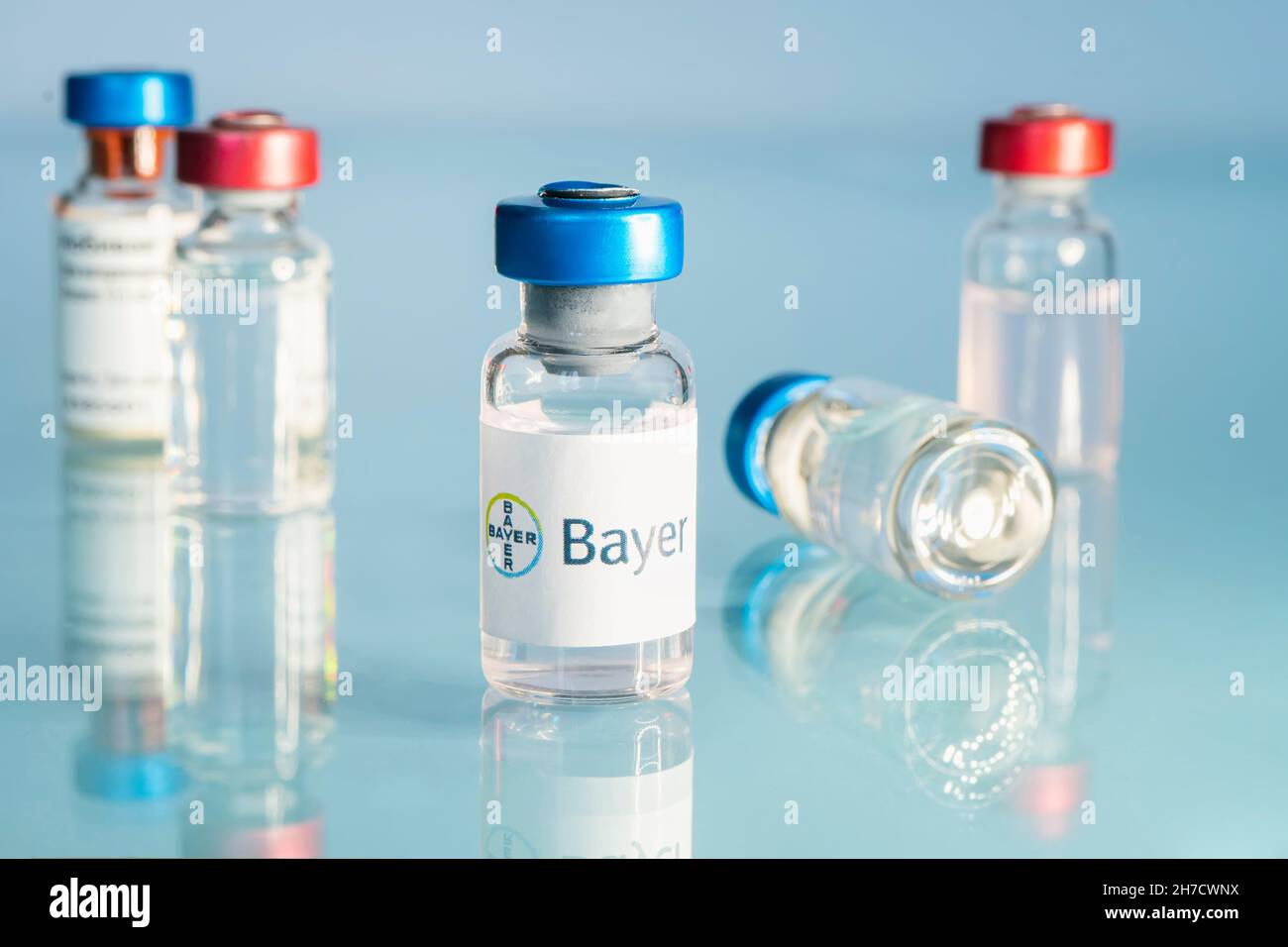 Vials of liquid on a white table and the logo Bayer, large ...