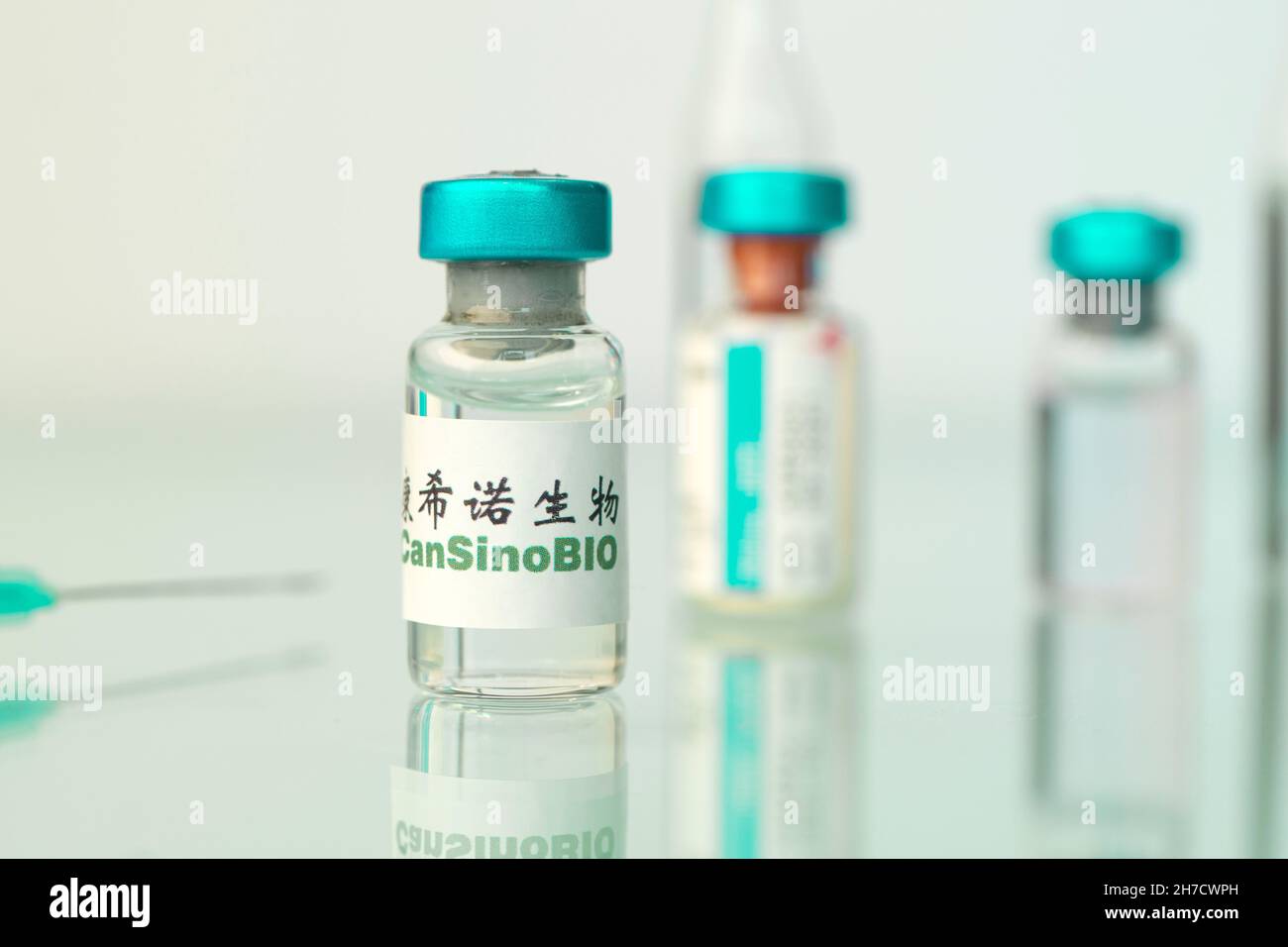 Vials of liquid on a white table and the logo CanSino Biologics, large ...