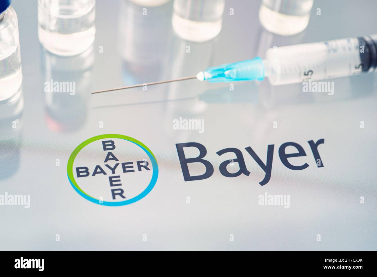 Vials of liquid on a white table and the logo Bayer, large ...