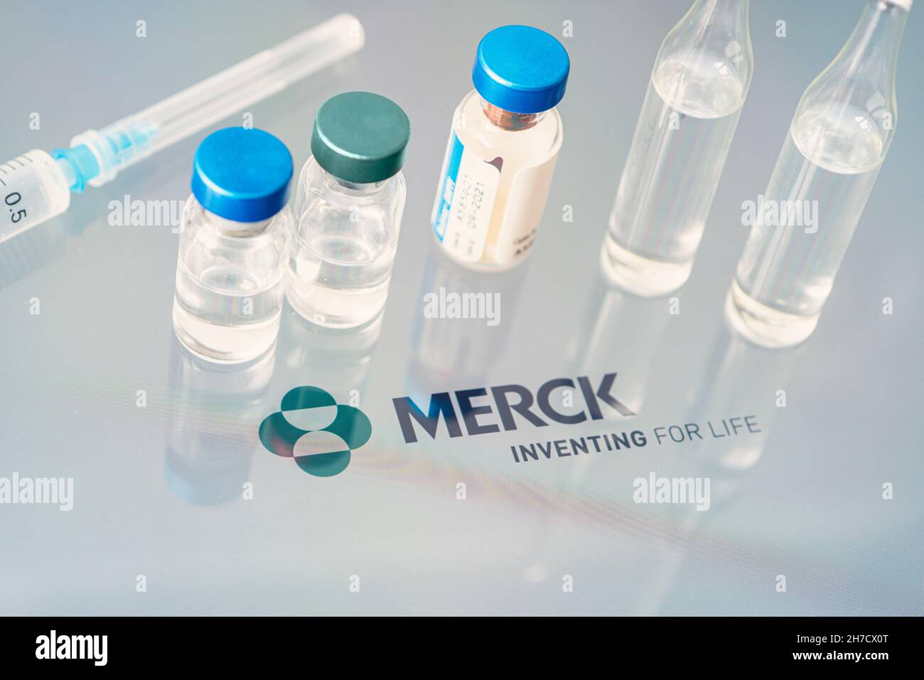 Vials of liquid on a white table and the logo Merck, large ...
