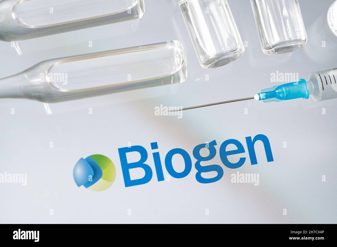 Vials of liquid on a white table and the logo Biogen, large ...