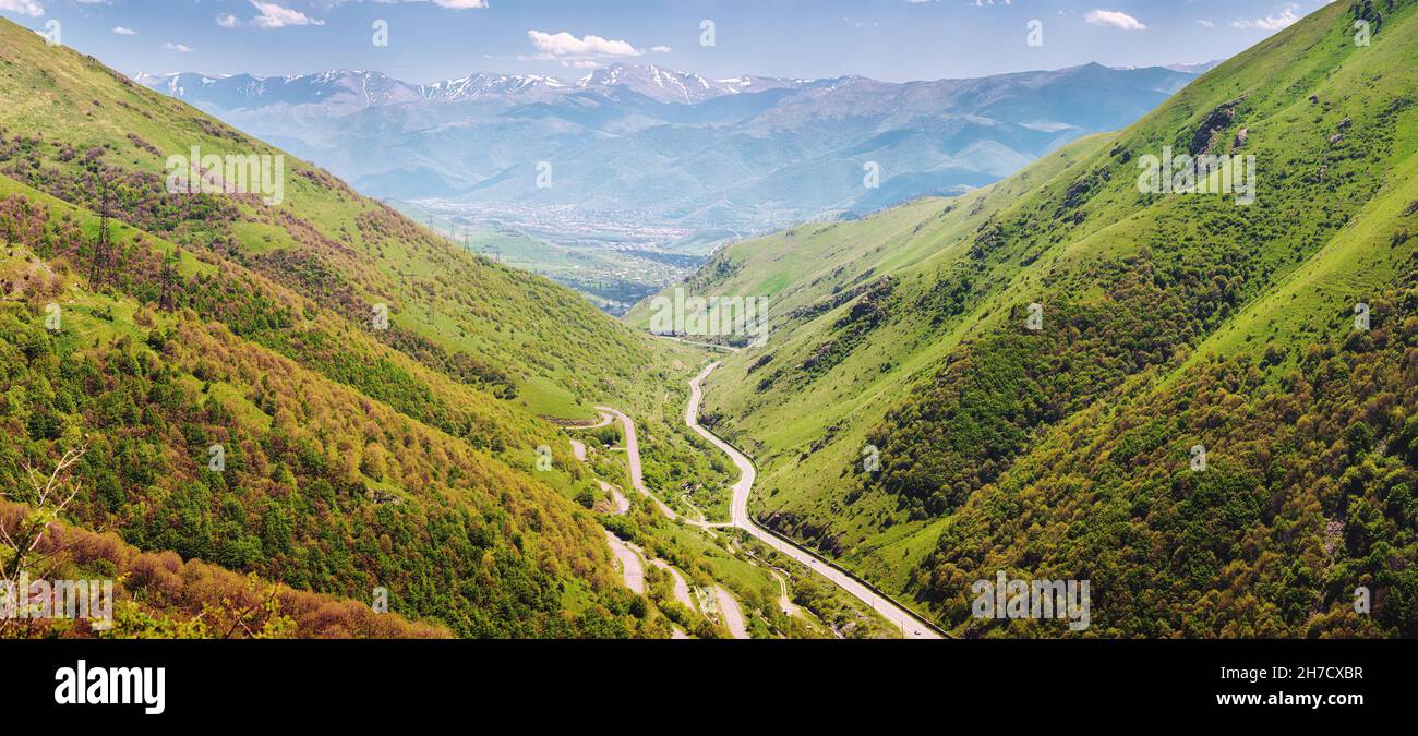 Aerial view of a mountain road in a gorge between two mountain ranges ...